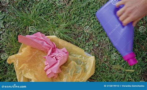 Volunteer Hands Sorting Plastic In Grass At Eco Friendly Cleanup Action