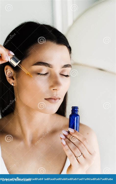 Young Woman With Acid Dropper Is Applying Drops Of Acid On Her Skin