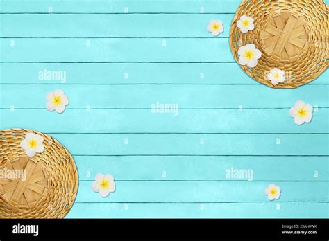 Straw Brown Hats With Plumeria Flowers On Blue Wooden Boards Vacation