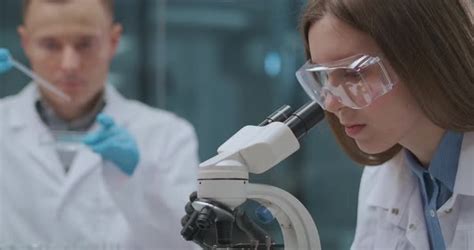 Microbiologists Are Researching Virus And Bacteria In Laboratory Woman