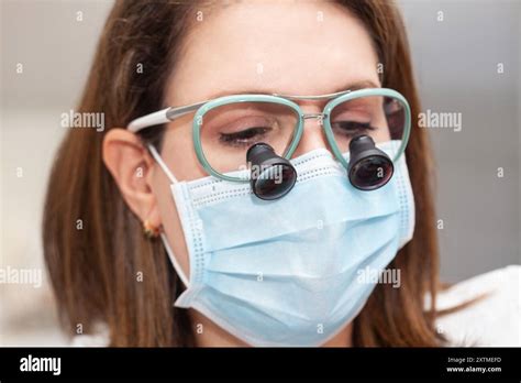 Close Up Of A Female Dermatologist Face While Suturing A Patient During
