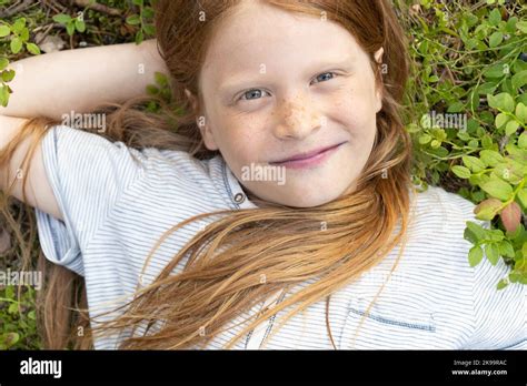 Portrait Of A Red Haired Boy With Long Hair On The Grass Flat Laythe