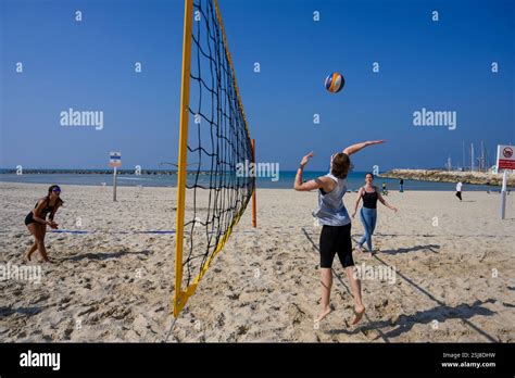 Four Young Women Are Playing Beach Volleyball On Gordon Beach Tel Aviv