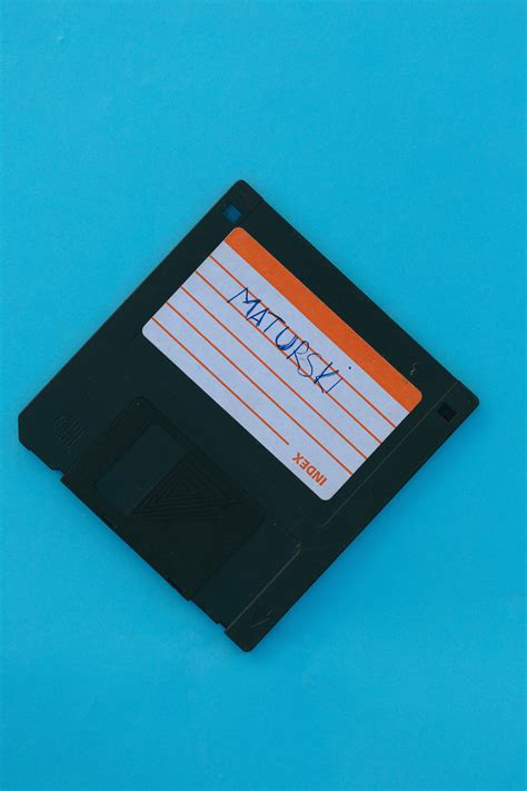 Free Picture Old Fashioned Data Storage Floppy Disk On Blue Background Close Up Photo