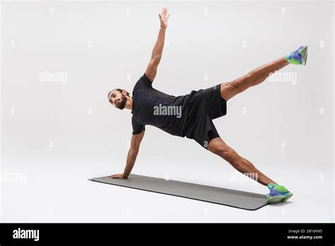 Image Of Attractive Brunette Sportsman In Tracksuit Doing Workout On