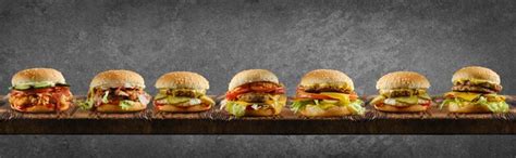 Premium Photo Assortment Of Different Types Of Burgers On Long Wooden Board