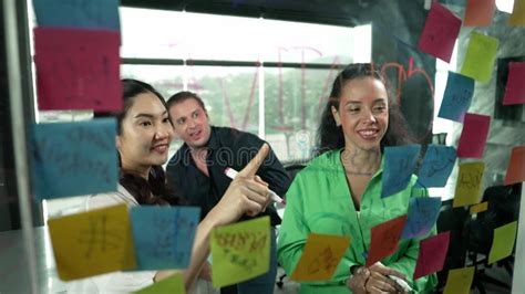 Business Team Brainstorming Marketing Idea By Using Sticky Notes