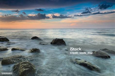 일몰에 바다의 놀라운 풍경 드라마틱한 하늘 파도 바위 투성이의 바다 해변의 다채로운 저녁 전망 긴 노출 이미지 바다 풍경의 개념 자연 배경 0명에 대한 스톡 사진 및 기타