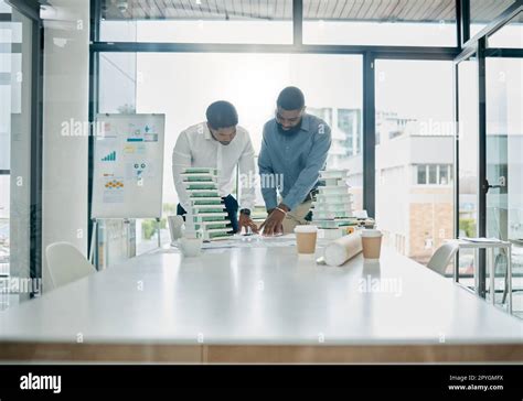 Planning Building Model And Architecture Team Analyzing A Construction Blueprint In An Office
