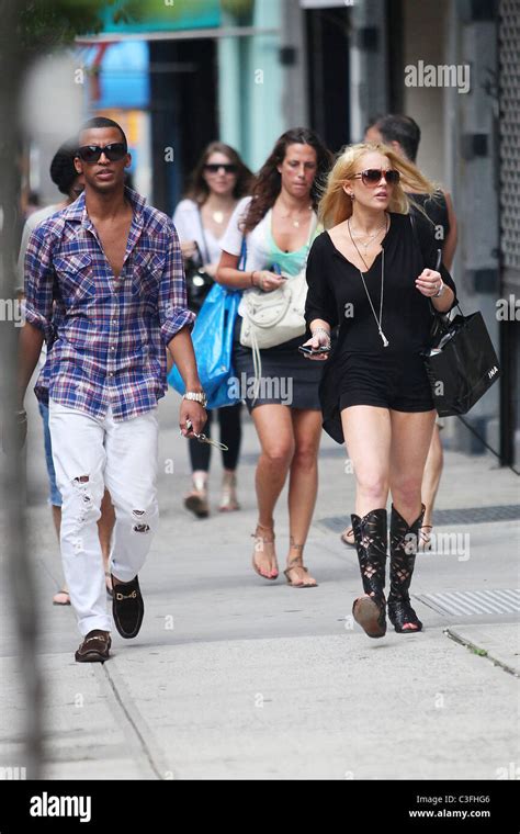 Lindsay Lohan Wearing A Little Black Dress And Knee High Strappy Boots