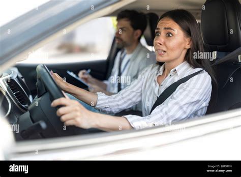 Scared Unconfident Woman Driving Car With Instructor By Her Side Stock Photo Alamy