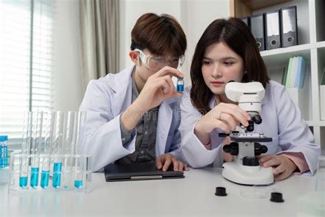 Young Researchers Performing Collaborative Sample Analysis In Laboratory Environment Stock Image