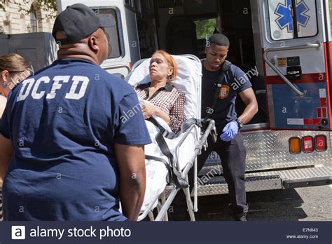 Dcfd Emt Loading Patient Into Ambulance Washington Dc Usa Stock
