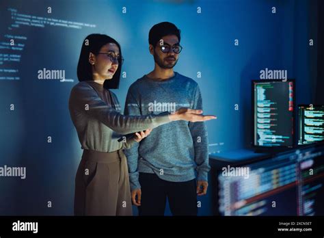 Asian Two Software Developers Engaged In Collaborative Coding Session