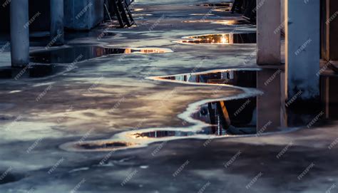 Premium Photo Puddle Water Reflection On Ground Parking Lot With
