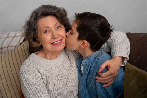 Free Photo Medium Shot Grandson Kissing Grandmother