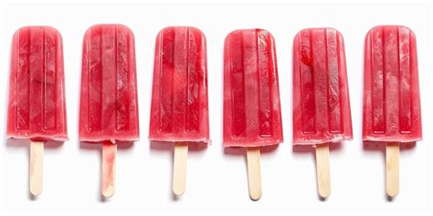 A Row Of Six Red Popsicles With Wooden Sticks Premium Ai Generated Image