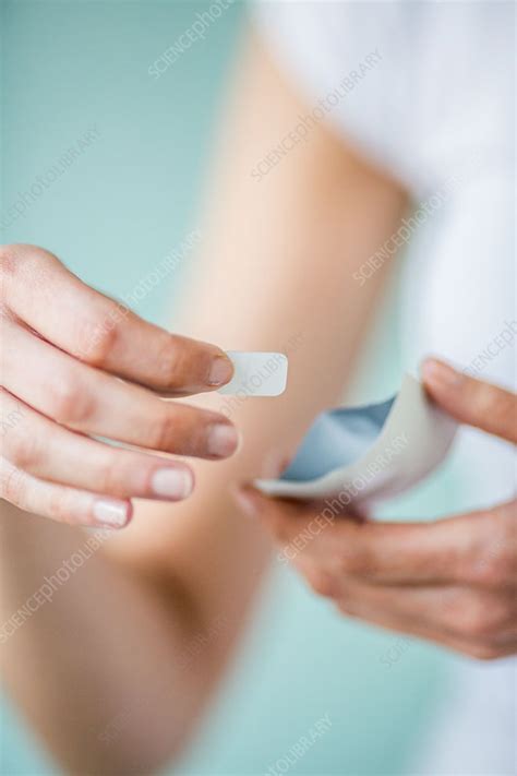 Woman Applying A Patch Stock Image C Science Photo Library