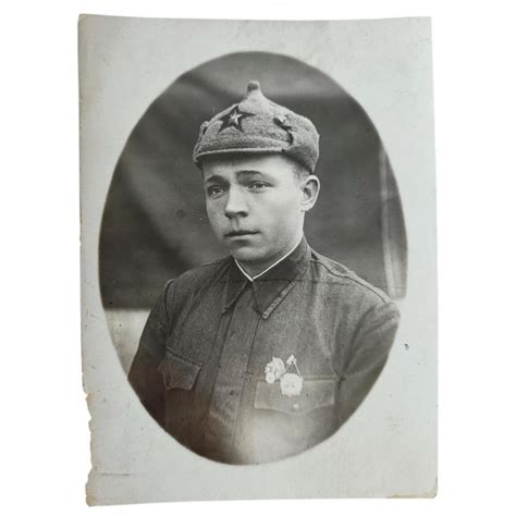 Red Army Soldier With Badges And Budyonovka Hat