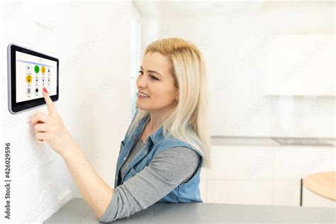 Smart Home Digital Thermostat Touch Screen Woman Touching Touchscreen To Adjust Temperature Of