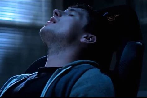 A Man Laying Down With His Head Up In The Air And Eyes Closed To The Side