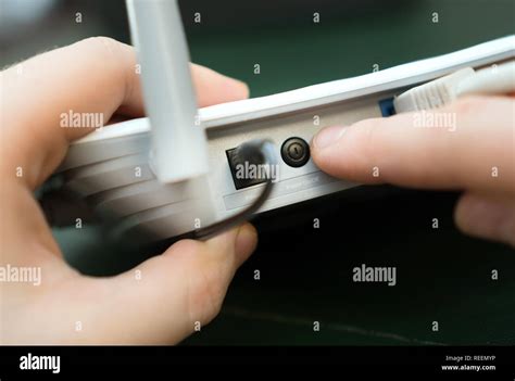 Man Pressing Power Button On The Wifi Router Stock Photo Alamy