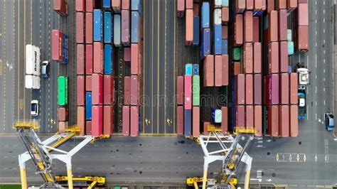 Overhead Top Down Aerial View Of Automated Cranes Moving Colorful Cargo