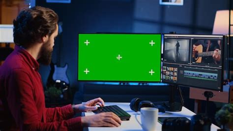 Premium Photo Videographer Uses Editing Software On Green Screen Computer To Assemble Footage