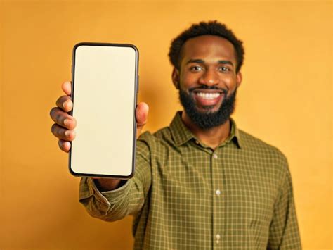 a man is holding a mobile phone and showing a blank white screen