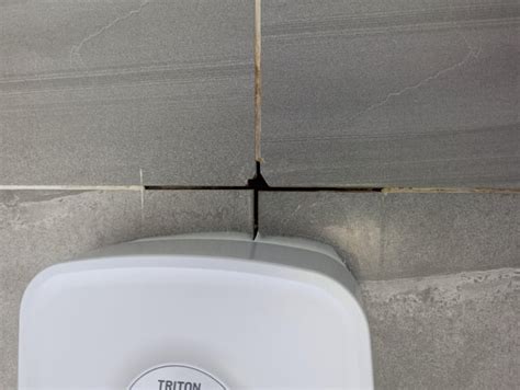 Large Gap Between Tiles Revealed After Replacing The Electric Shower