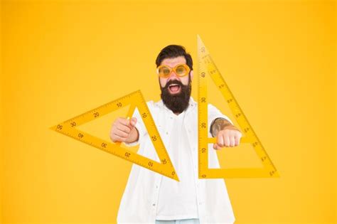 Premium Photo Leading Engineer Of The Project Smart Engineer Holding Triangles On Yellow