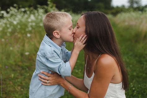 A Sweet Candid Kiss Between A Mother And Her Son By Stocksy