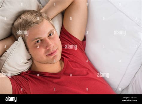 Man Lying Down On Sofa And Relaxing Stock Photo Alamy