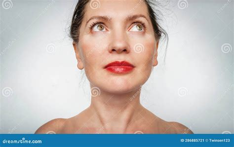Close Up Portrait Of Middle Aged Woman Captured In Wide Angle Showcasing Expressive Face Bare