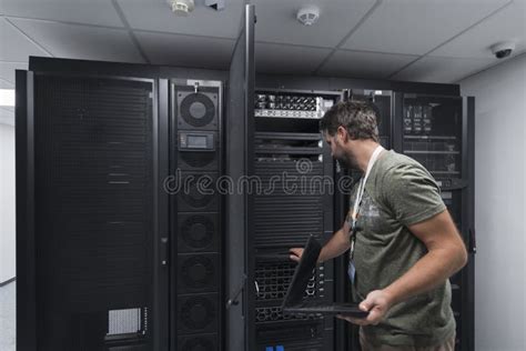 Data Center Engineer Usaing Keyboard On A Supercomputer Server Room Specialist Facility With