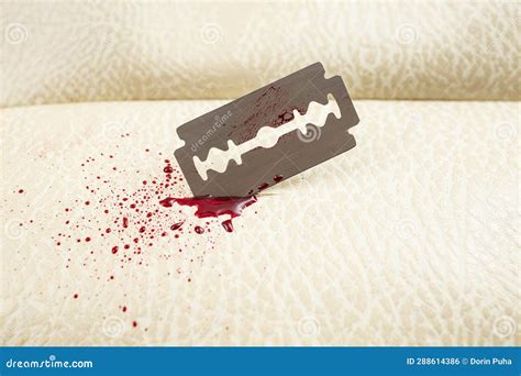Razor Blade With Blood Splash And Blood Drops Cutting Thru Beige