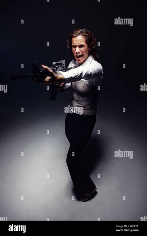 In The Mood To Shoot Full Length Shot Of An Aggressive Woman Standing Under A Spotlight And