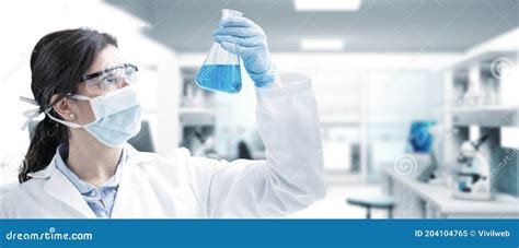 Female Scientist Measuring Blue Liquid In A Flask At A Chemical Laboratory Stock Image Image