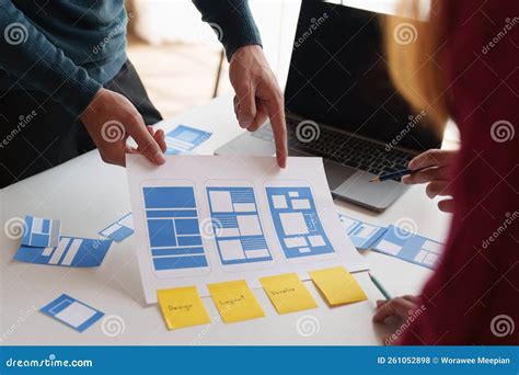 Group Of Ux Developer And Ui Designer Brainstorming About App Interface