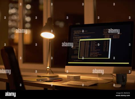 Close Up Of Workplace Of Developer With Computer With Security Codes On Monitor In Dark Office