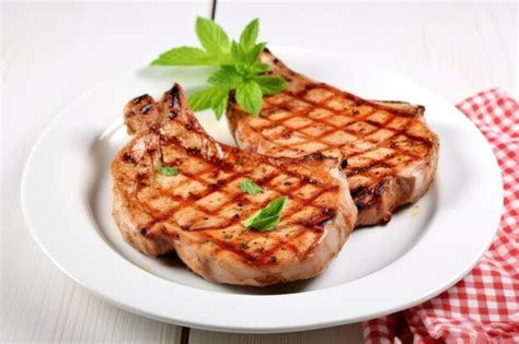 Premium AI Image Grilled Pork Chops On A White Ceramic Plate