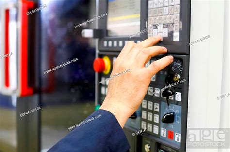 Operator Working With CNC Machining Center Using Control Panel Stock Photo Picture And Low