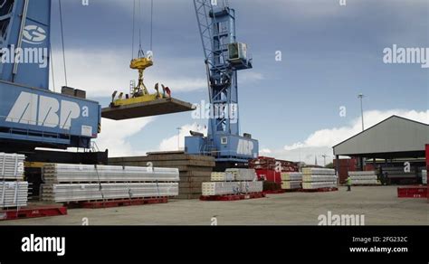 Industrial Crane Loading And Unloading Cargo Containers At A Busy Port Stock Video Footage Alamy