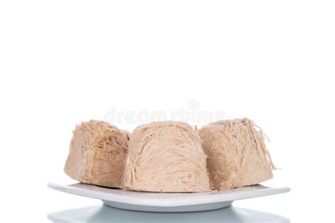 Several Pieces Of Sweet Stringy Halva With Ceramic Dishes Macro Isolated On White Background