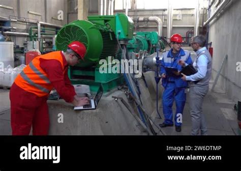 Technical Manager With Digital Tablet Talking To Factory Worker In Protective Equipment Digital