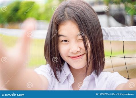 Girl Winking With Thumb Up And Ok Sign Stock Image