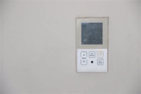 Close Up Of A White Ac Control Unit With A Green Backlit Display