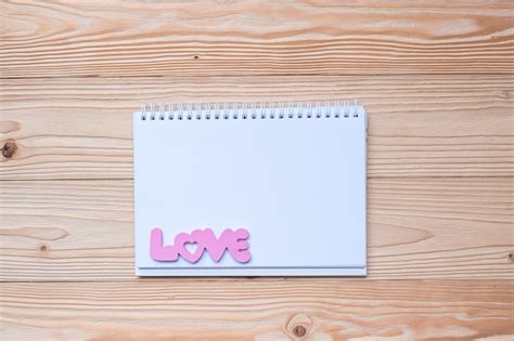 Premium Photo Love Text With Notebook On Wooden Table Background