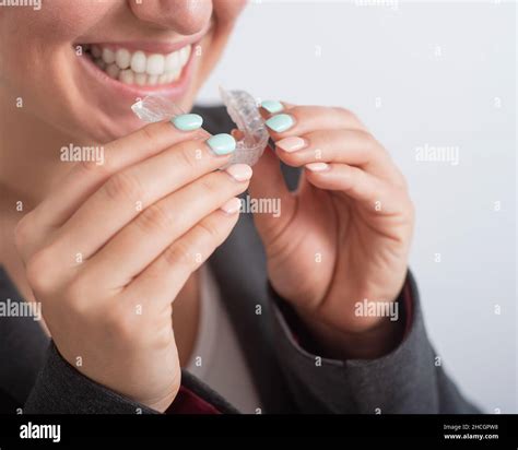 Close Up Of A Woman Putting On Transparent Plastic Retainers The Girl Uses A Device To