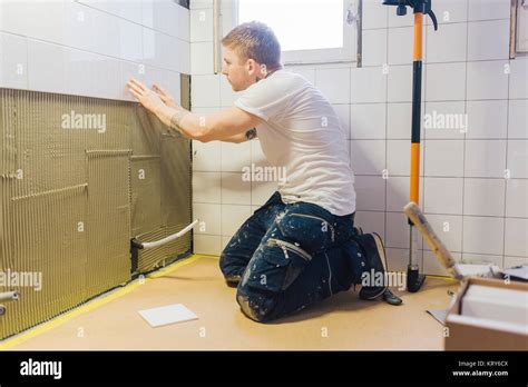 Man Tiling A Wall Stock Photo Alamy